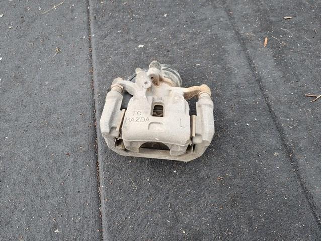 KAY02671X Mazda суппорт тормозной (левый r052/16d)